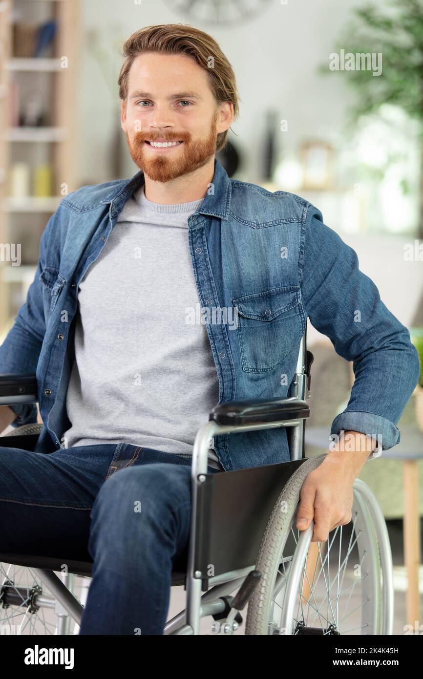 optimistic handicapped man sitting on wheelchair Stock Photo - Alamy