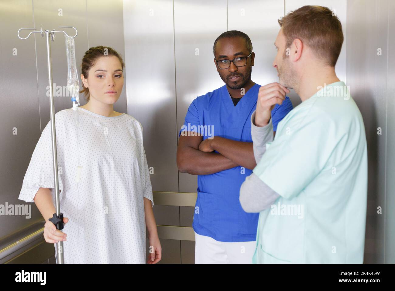 doctors and female patient in elevator Stock Photo - Alamy