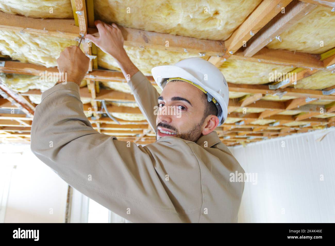 young man fixing a wood ceiling Stock Photo - Alamy