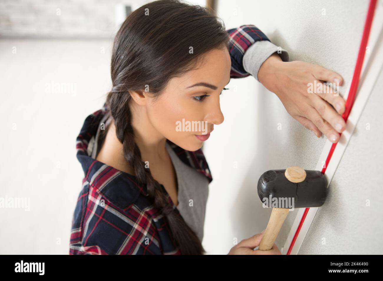 Woman hammering a nail hi-res stock photography and images - Alamy