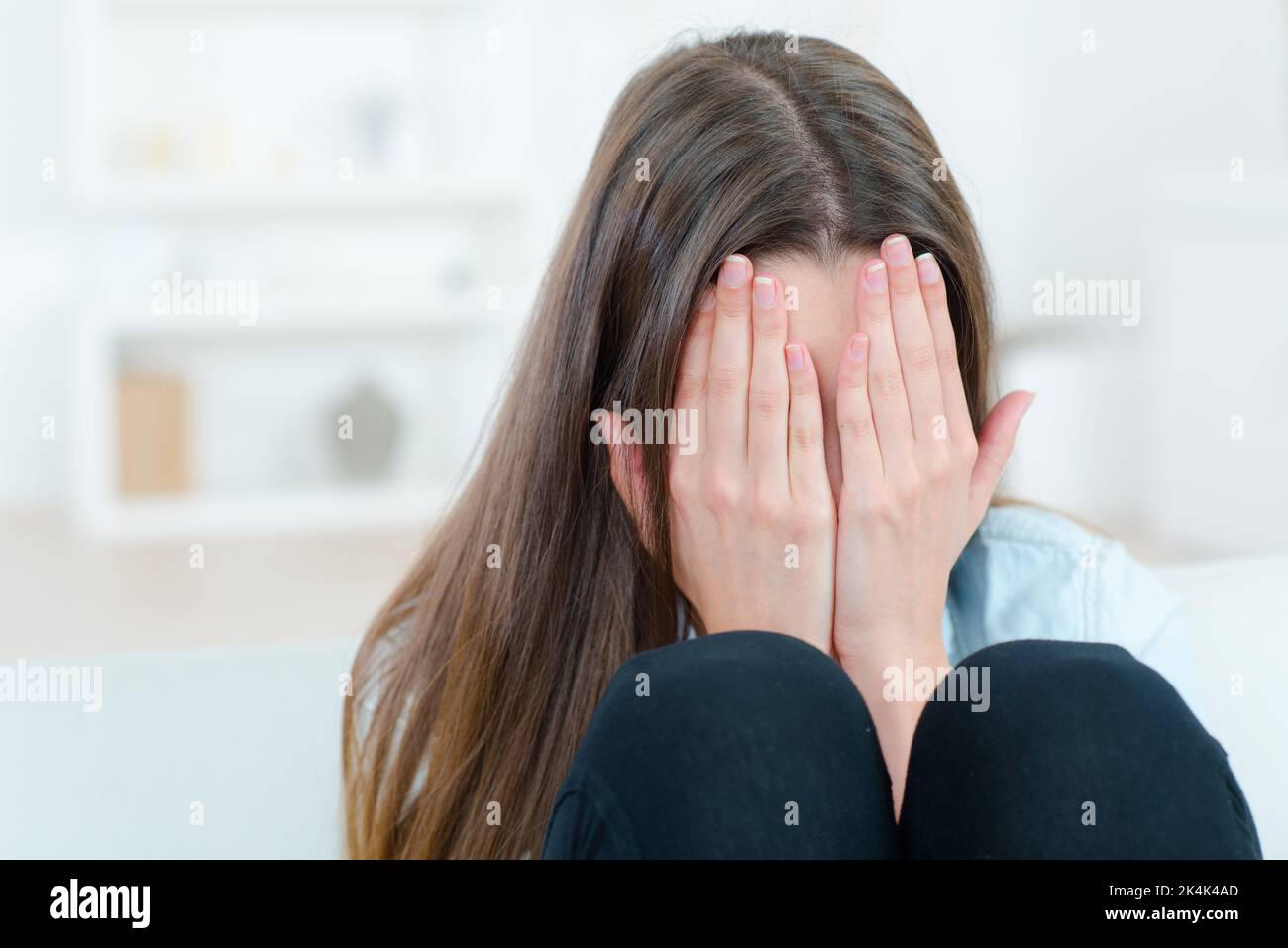 a woman hiding her face Stock Photo - Alamy