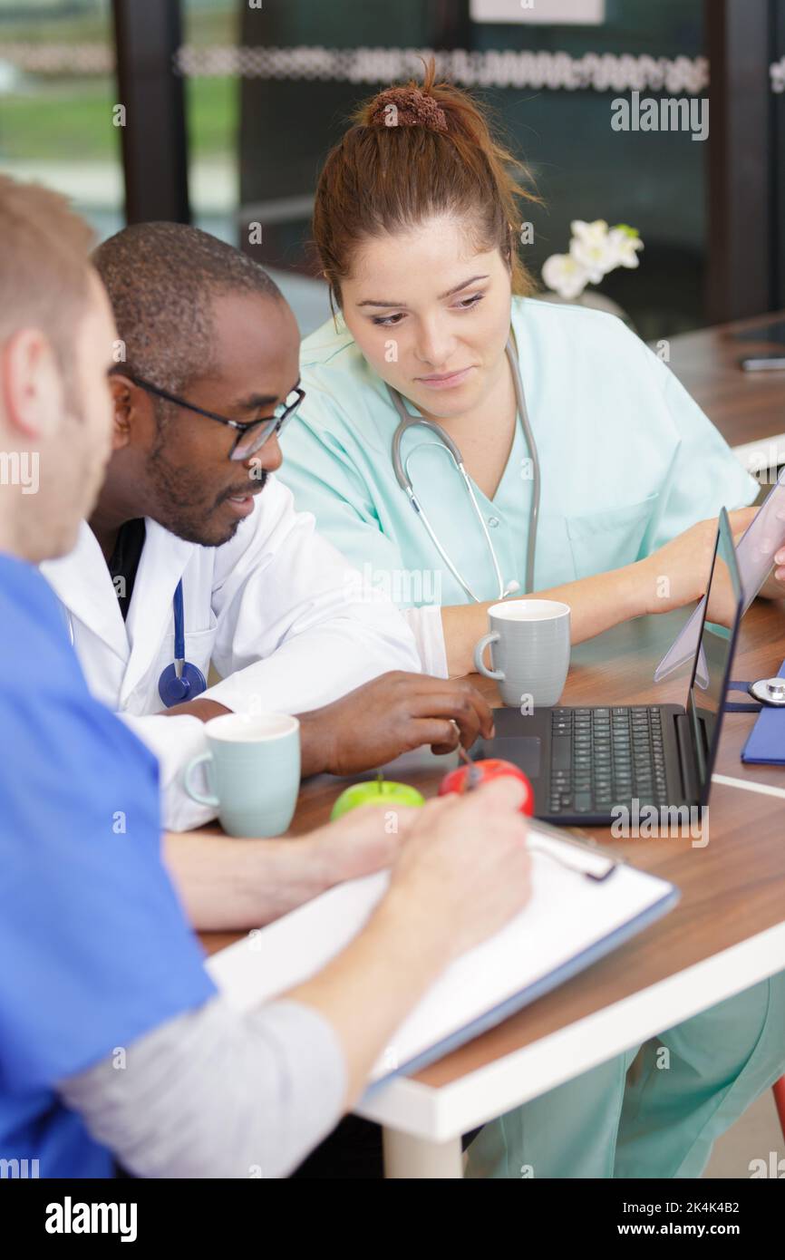 young doctor smiling checking pc Stock Photo - Alamy