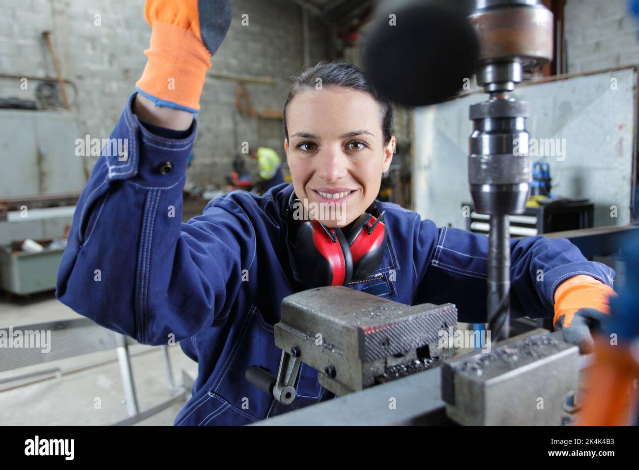 happy mechanic apprentice working on milling machine Stock Photo - Alamy