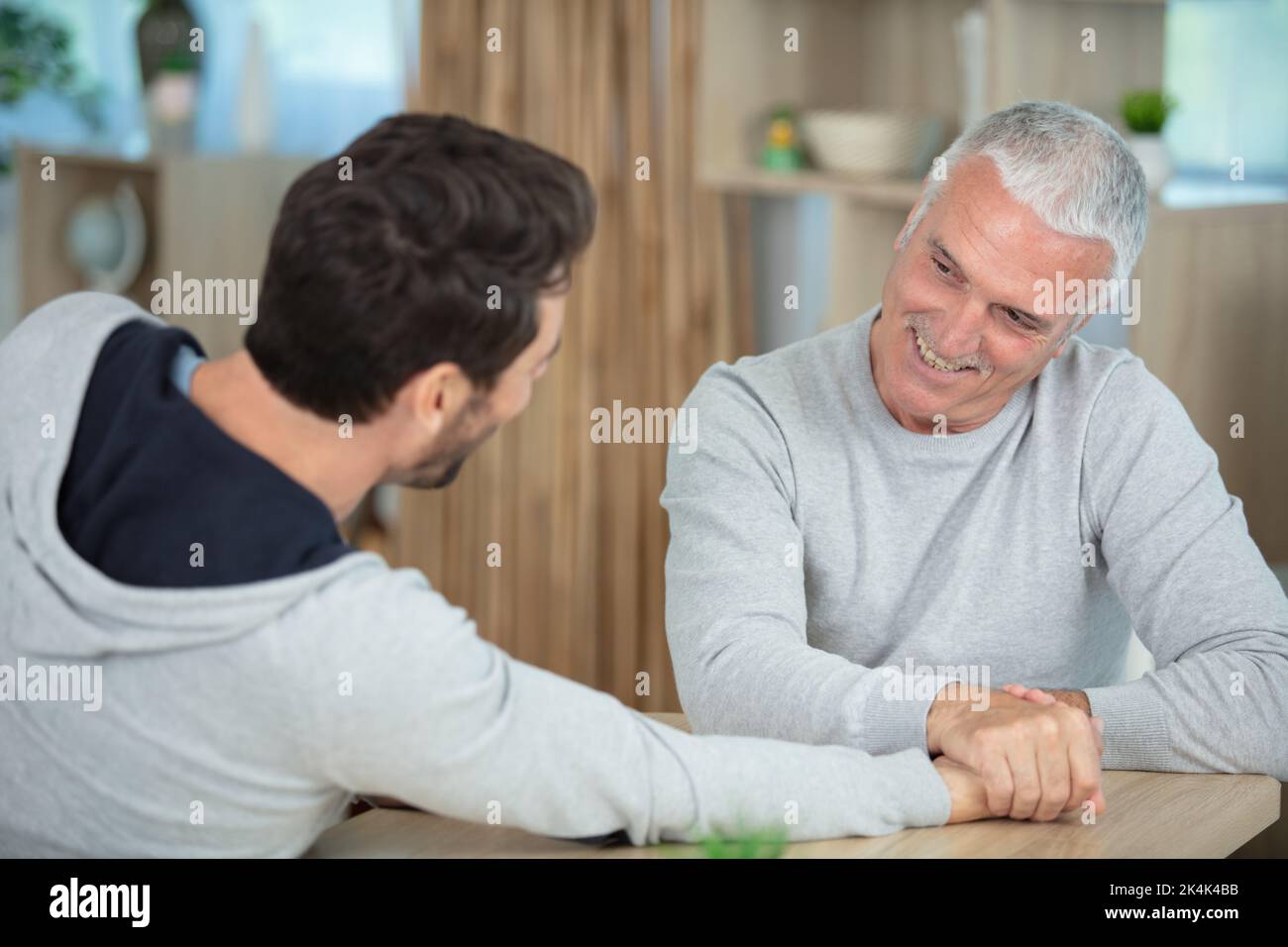 nice happy positive father and son playing arm wrestling Stock Photo ...
