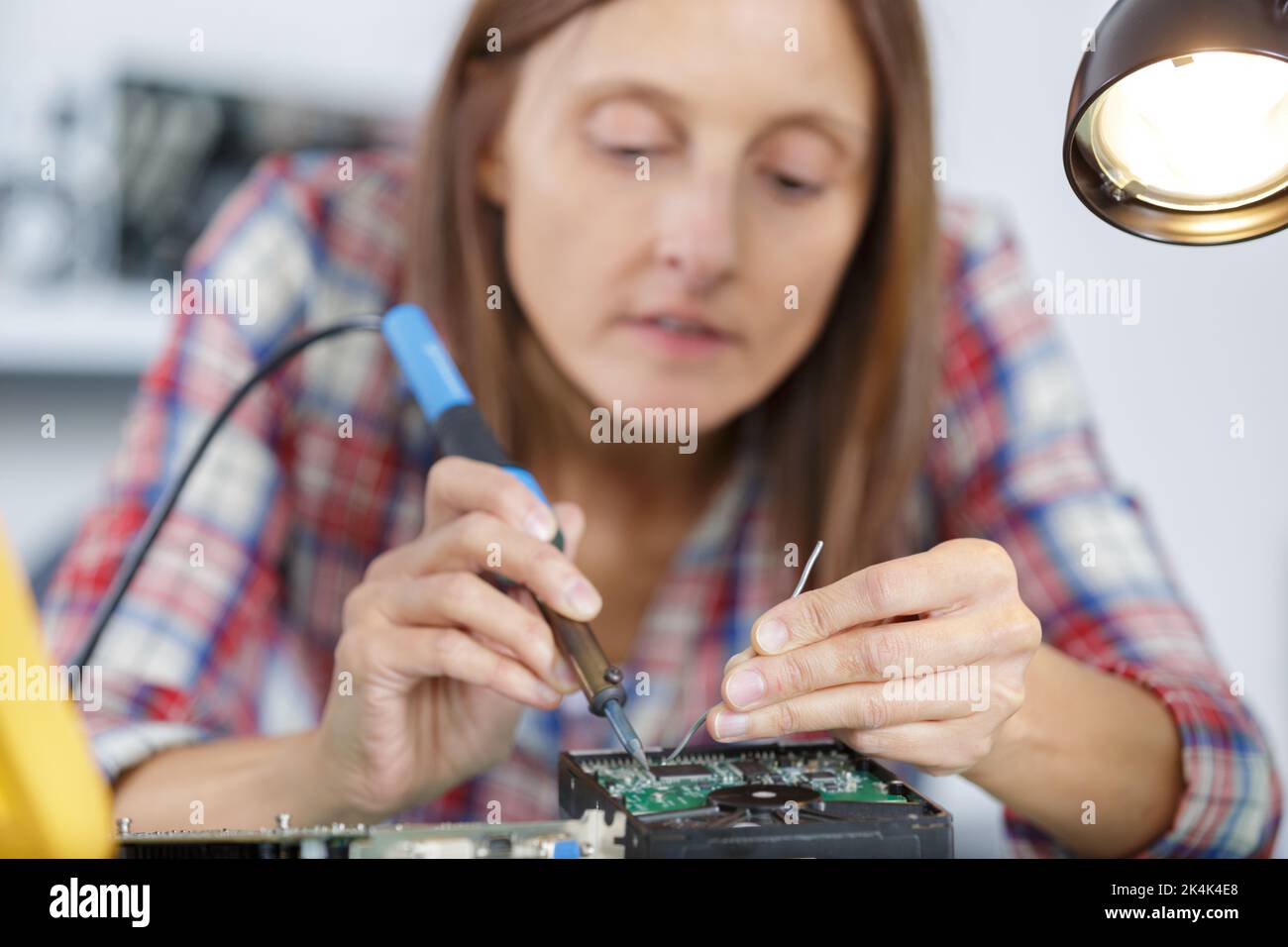 female engineer fixing broken computer hard drive Stock Photo - Alamy