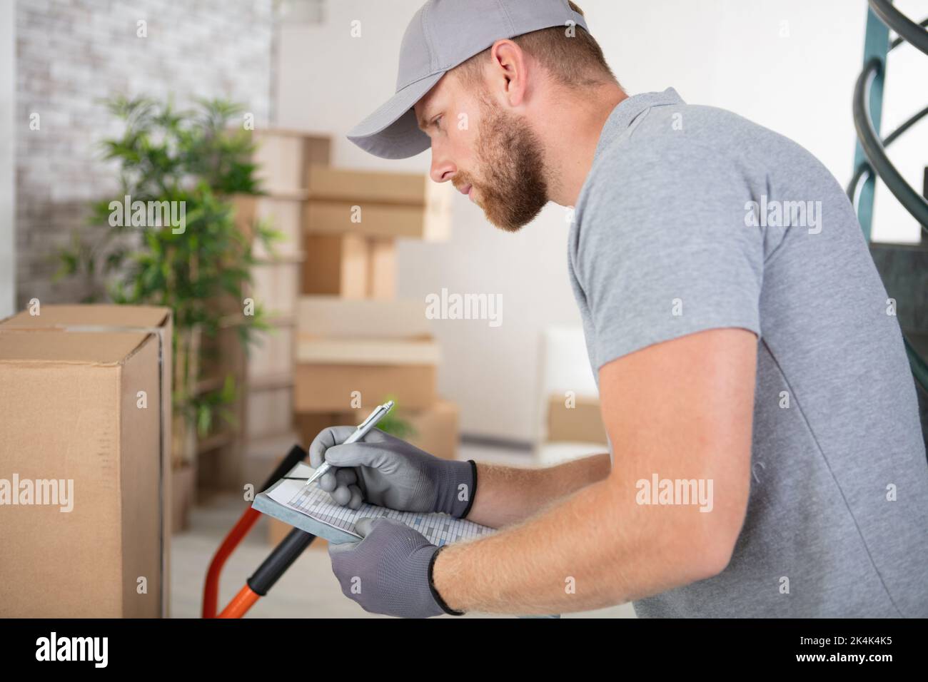 delivery man uses hand truck trolley Stock Photo - Alamy