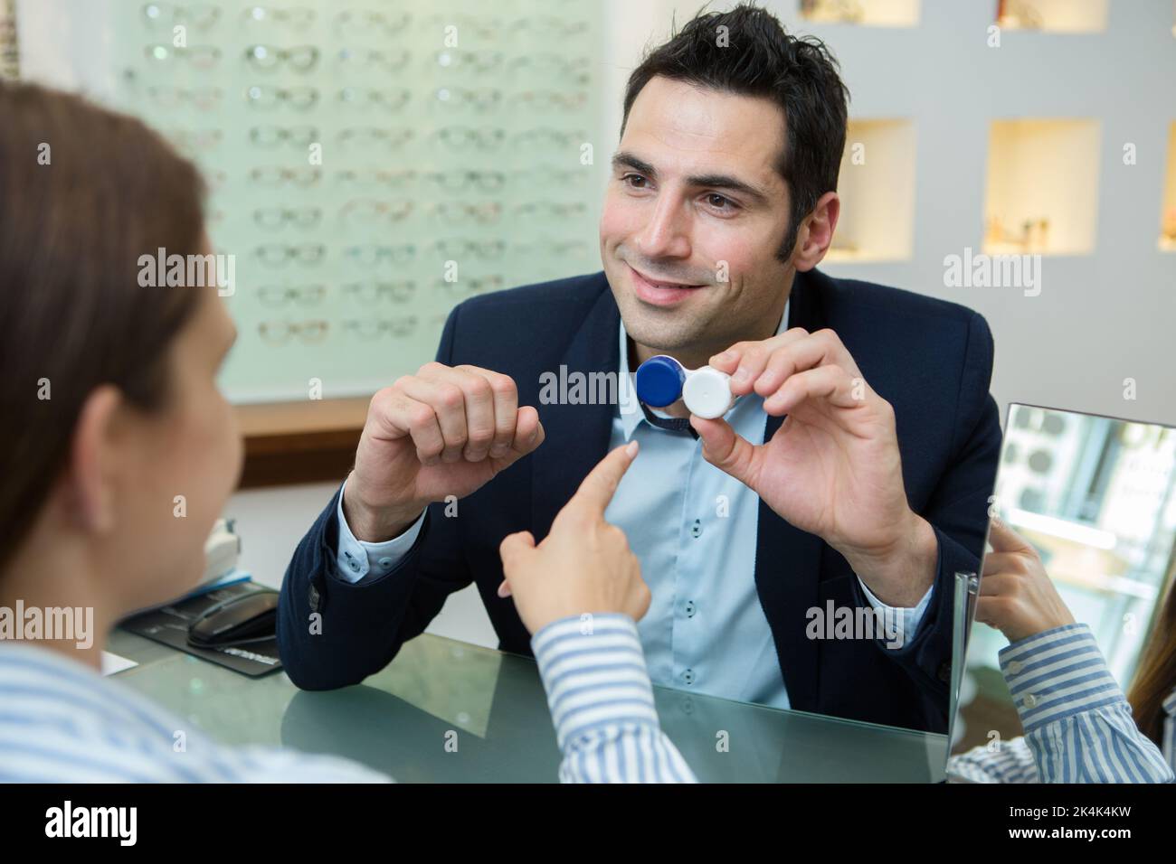 an optician holding optical lenses Stock Photo - Alamy