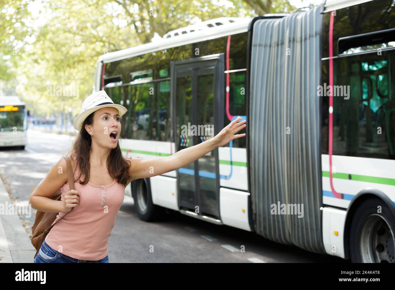 upset woman runs after the bus that leaves Stock Photo - Alamy