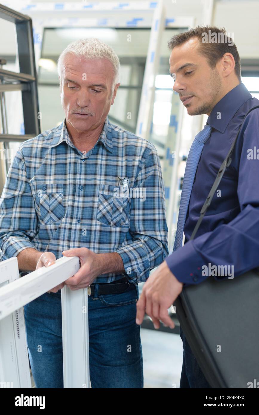portrait of two workers checking windows Stock Photo - Alamy