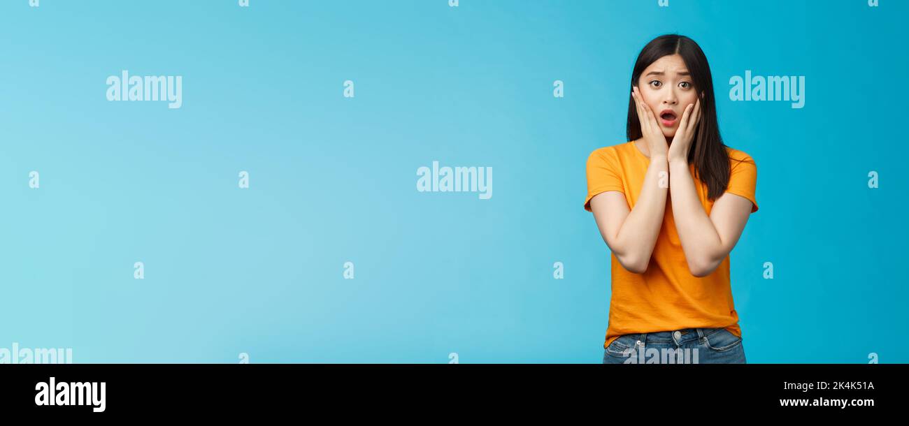 Shocked concerned young asian girl look empathy camera, gasping open ...