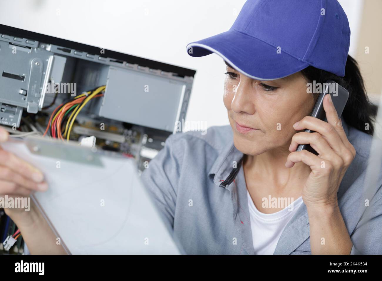 female pc technician soldering a chip from a desktop computer Stock ...