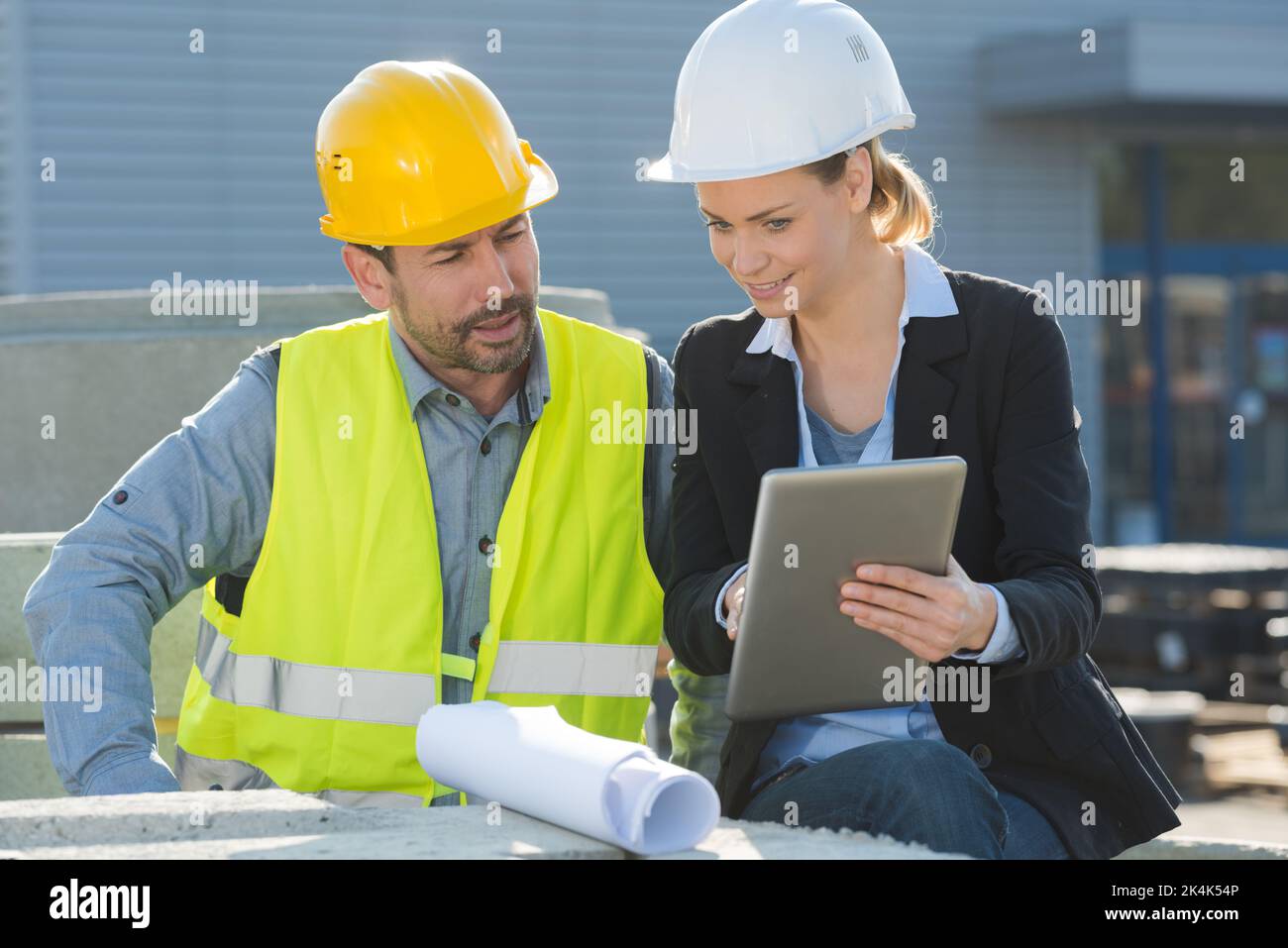 recycling industry workers using tablet outside factory Stock Photo - Alamy