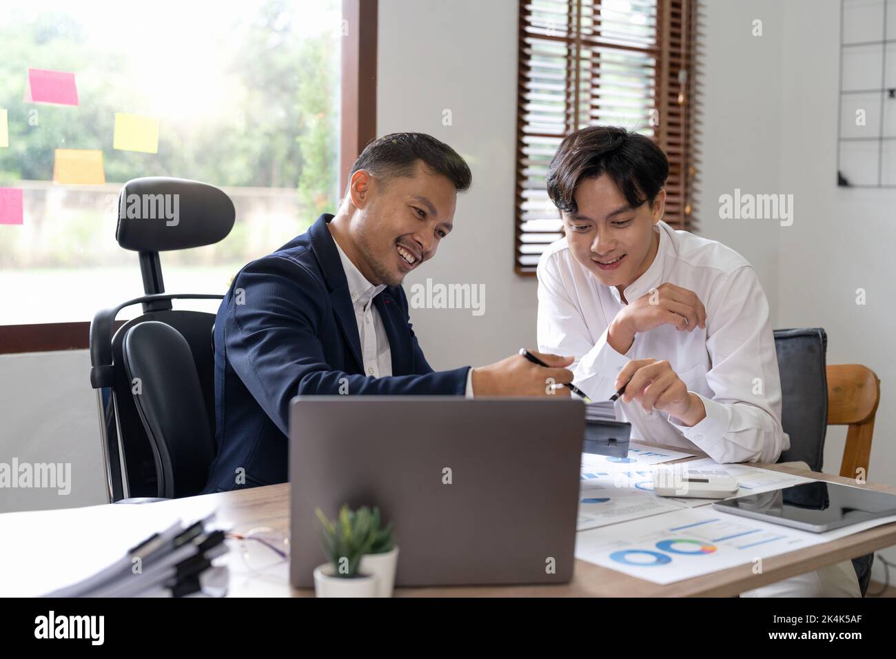 Financial advisory concept. Asian advisor showing plan of investment to ...