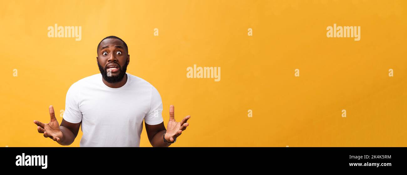 Portrait of african american man with hands raised in shock and ...