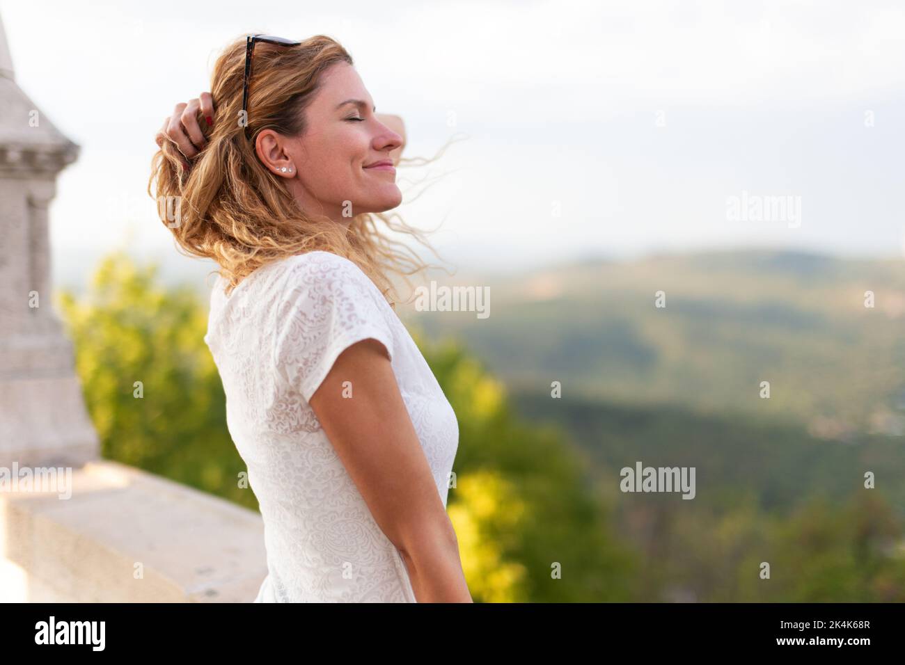 Young natural Caucasian woman balanced woman relaxing outdoors while ...