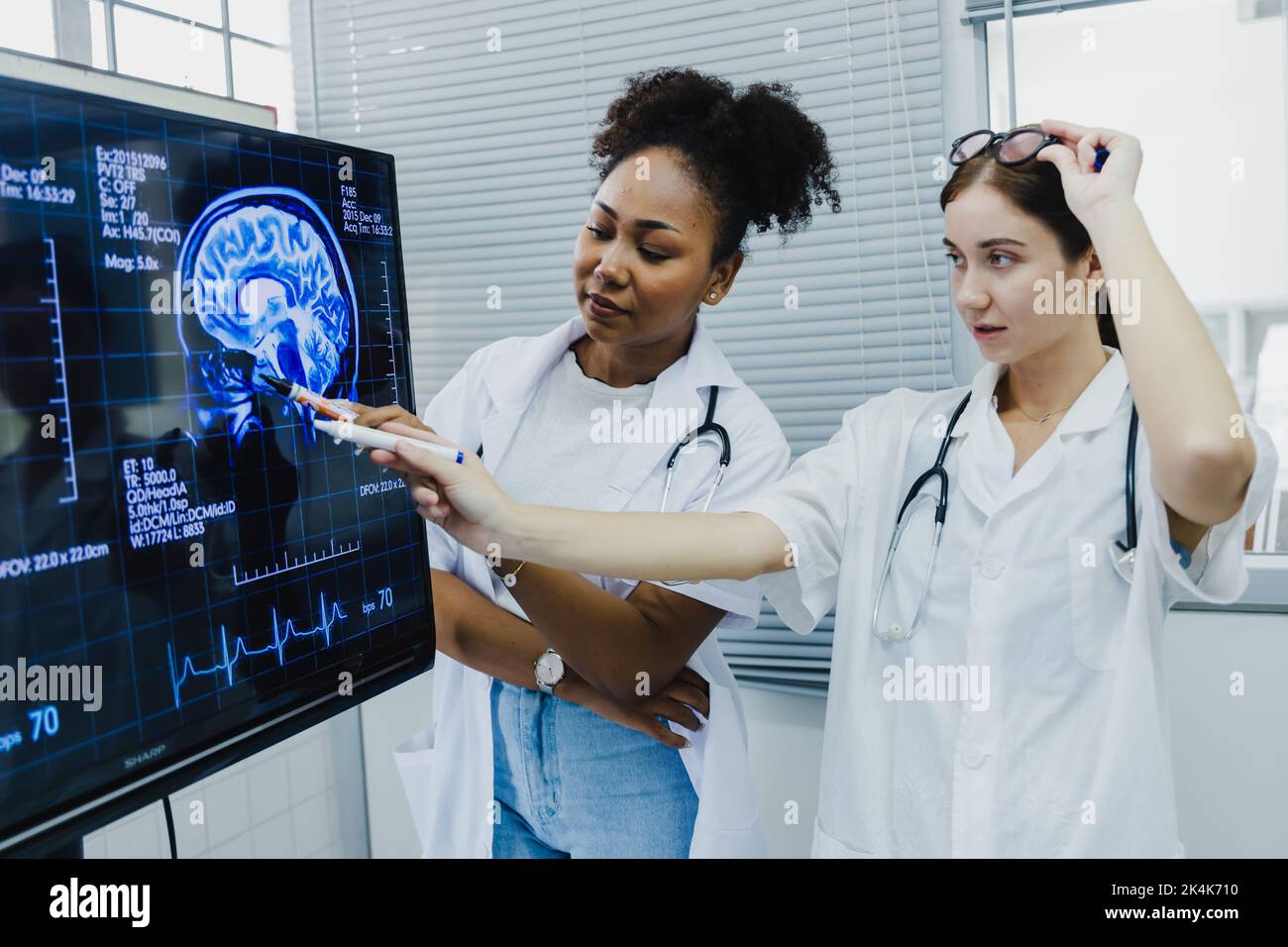 Team of female doctor check on scan results paper and looking at ...