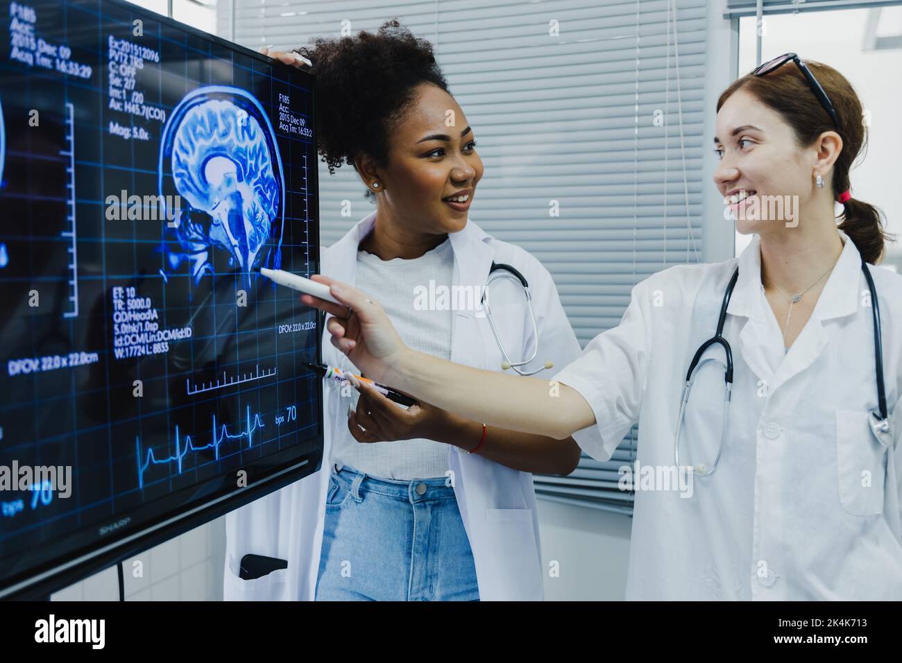 Team of female doctor check on scan results paper and looking at ...