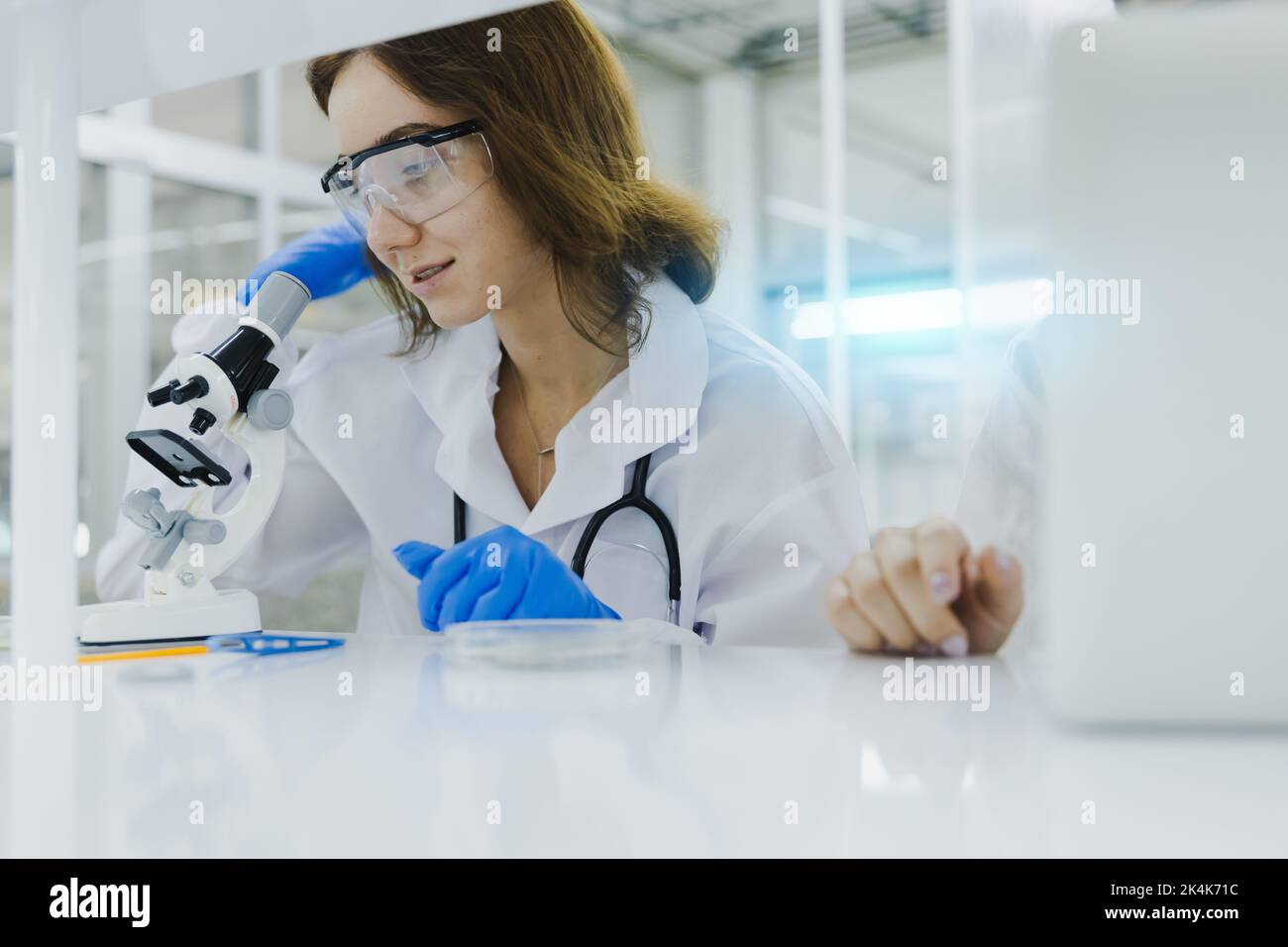 Young scientist using a microscope hi-res stock photography and images ...