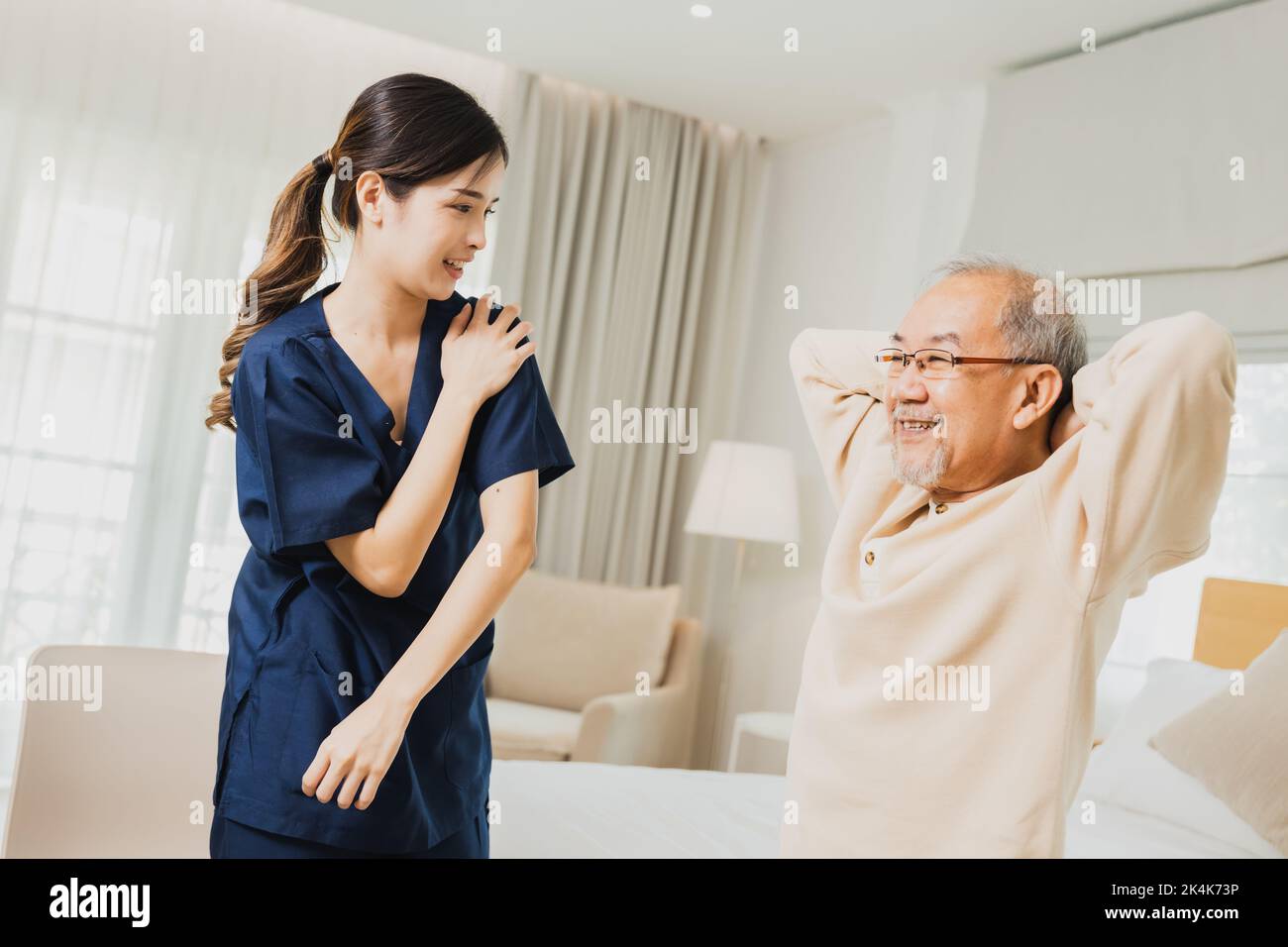 Female Physiotherapist Helping Senior Man Exercise Helping Elderly