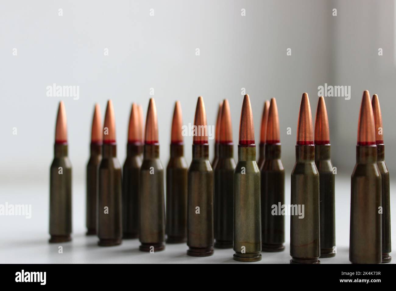 Live ammunition for assault rifle with red mark on a bullets in a row ...