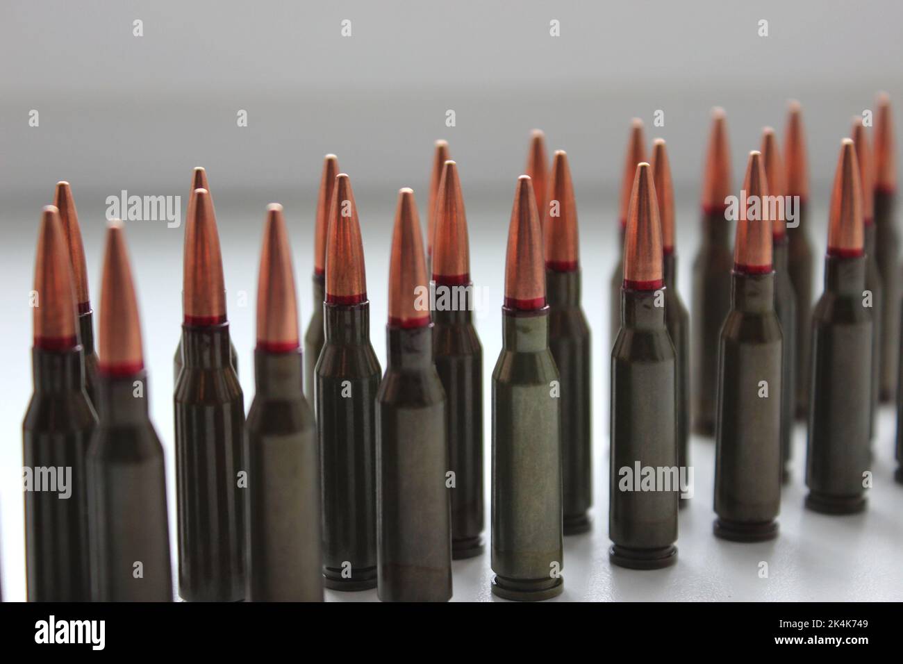 Mild steel core ammunition for automatic rifle lined up on a white ...