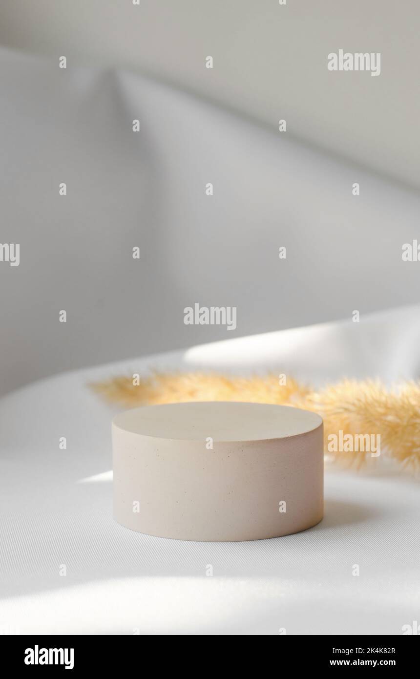 Round plaster podium for advertising cosmetic products on a delicate ...