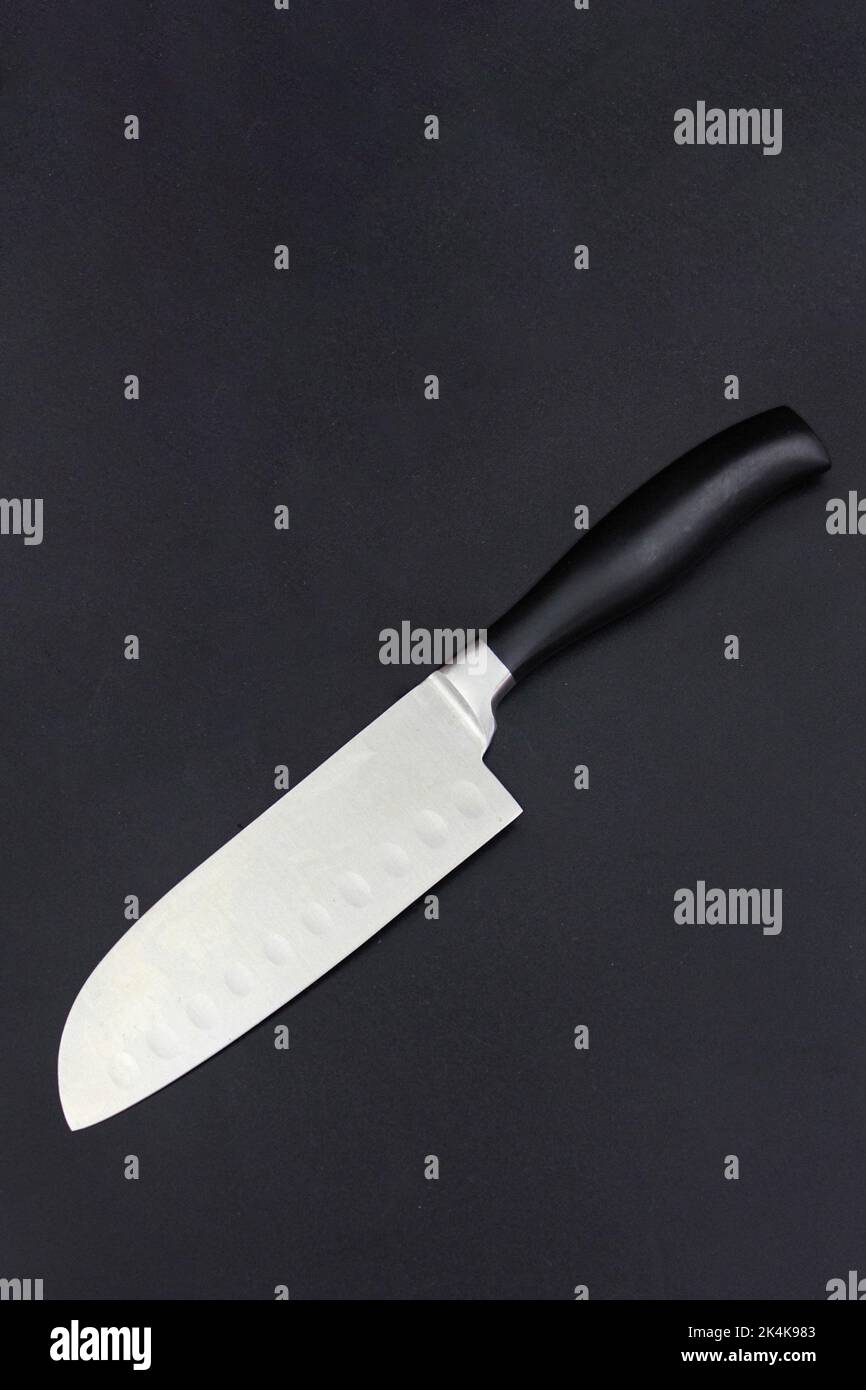 Sharp large kitchen knife on a dark surface Stock Photo - Alamy