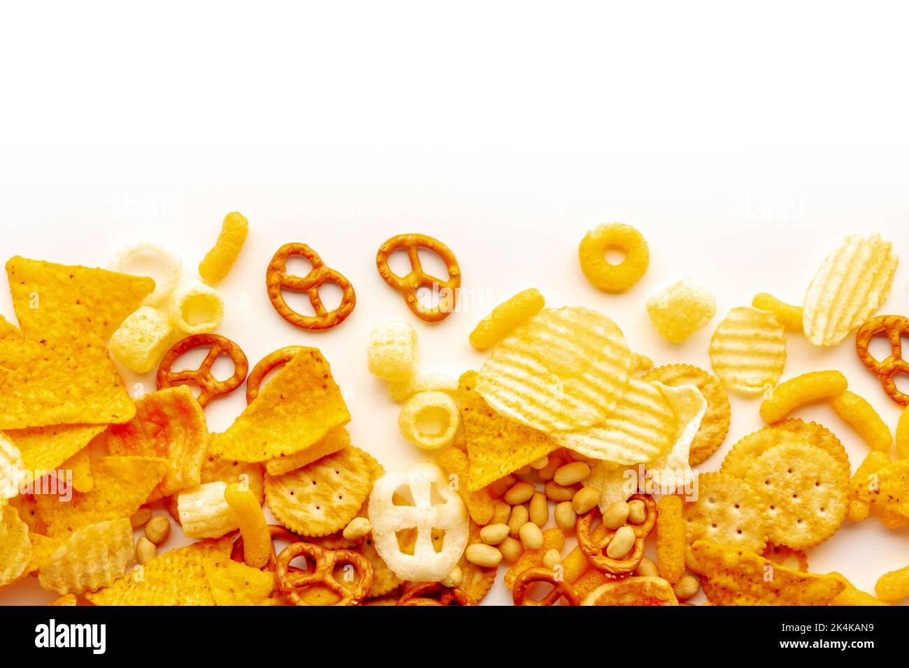 Salty snacks on a white background with copy space. Potato and tortilla ...