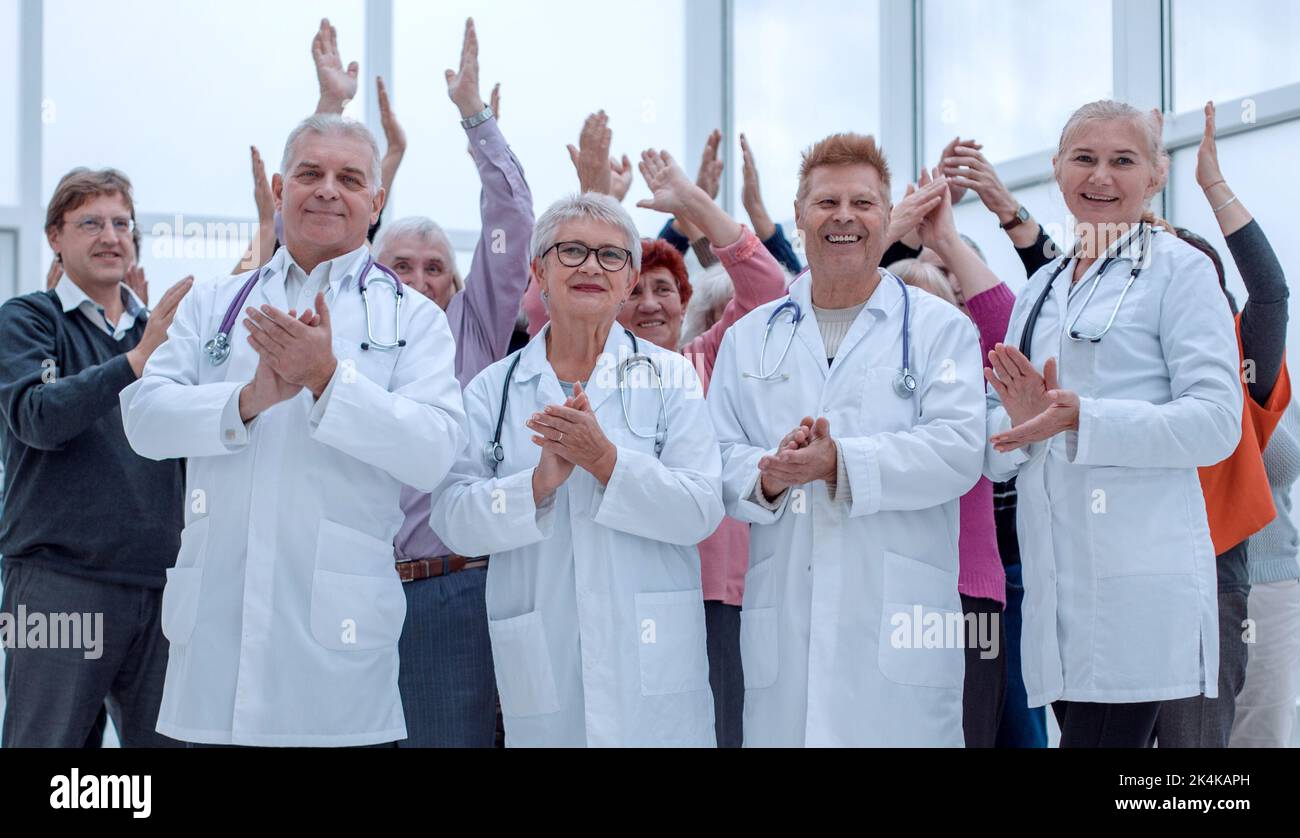 doctors and a group of mature people applaud Stock Photo - Alamy