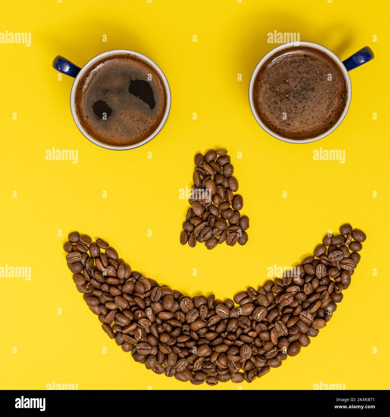 A smiling emoticon, lips made of coffee beans, and eyes made of coffee ...
