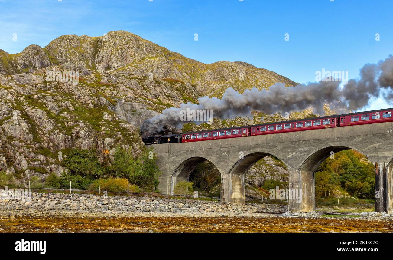 JACOBITE STEAM TRAIN AND DARK SMOKE FROM THE ENGINE AS IT CROSSES THE ...