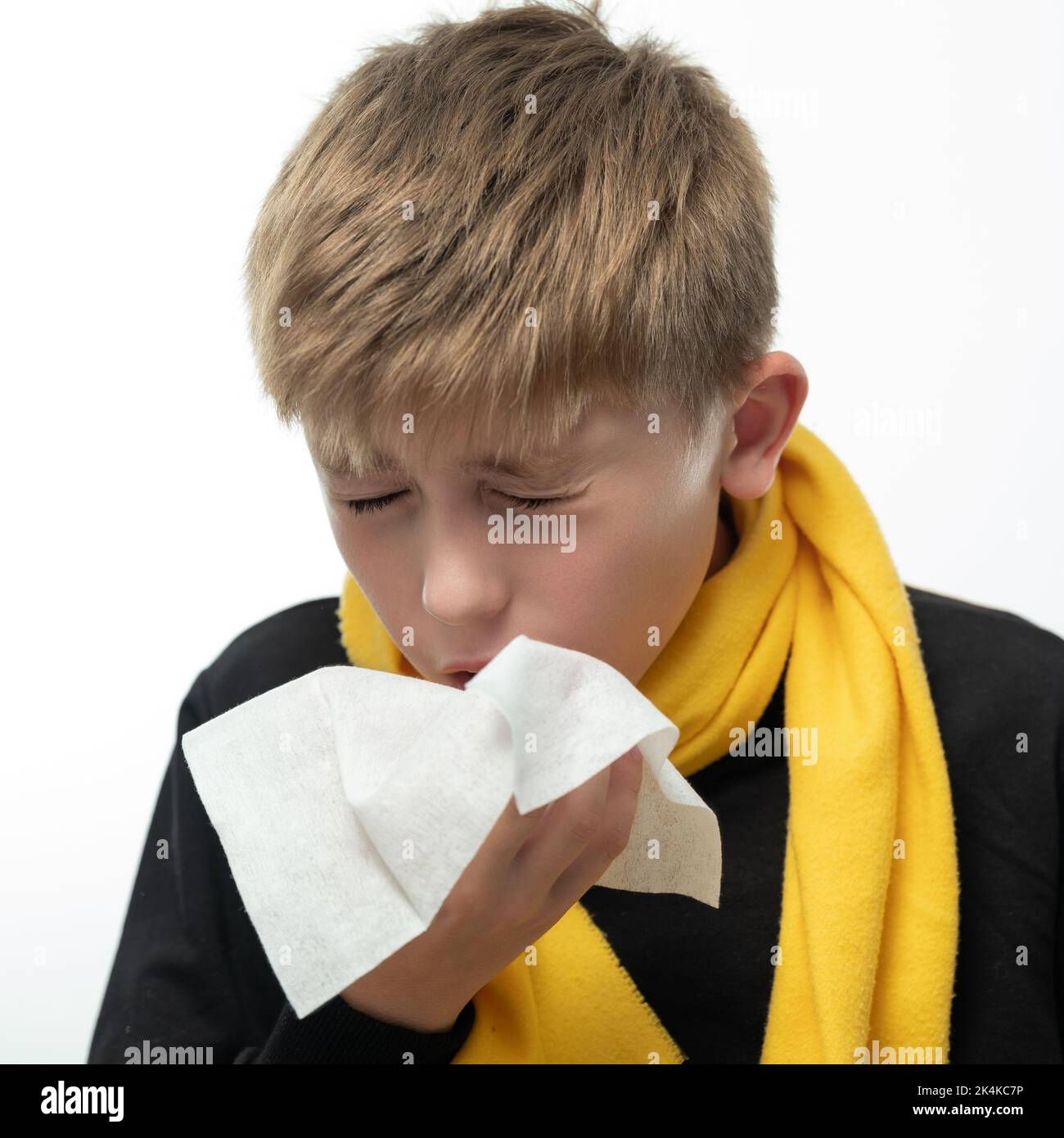 The child sneezes into a handkerchief, symptoms of colds Stock Photo ...