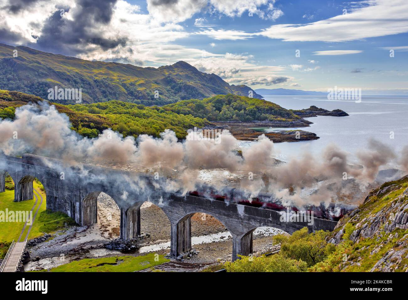 JACOBITE STEAM TRAIN THE RED COACHES ENTERING THE TUNNEL AND DENSE ...