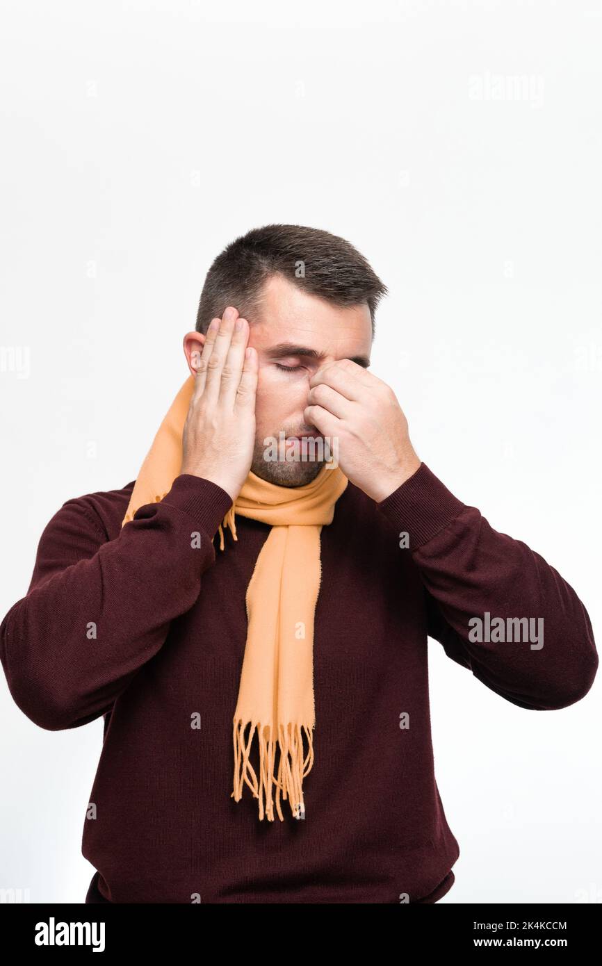 A man holds his hand on his head because of a headache, portrait of a ...