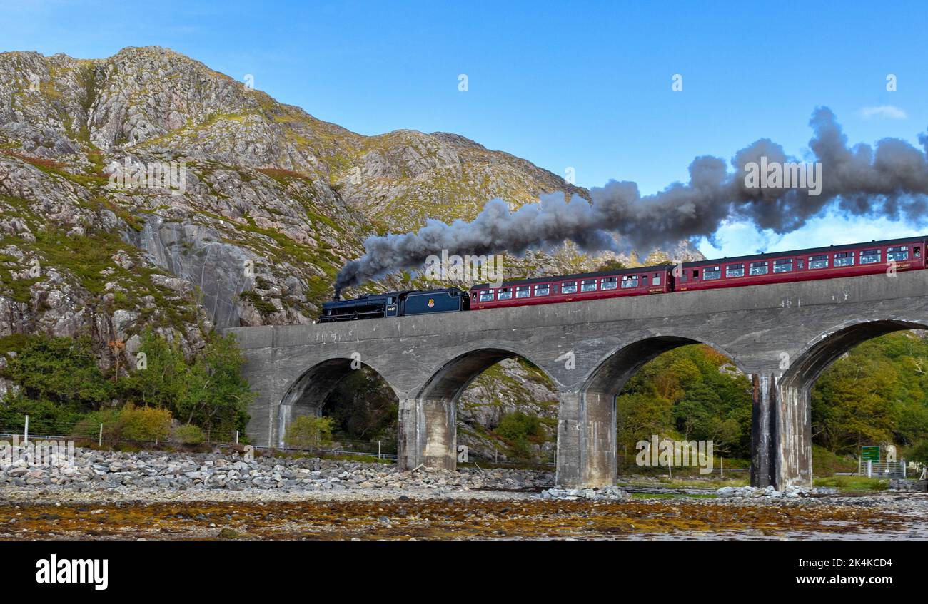 JACOBITE STEAM TRAIN WITH DARK SMOKE FROM THE ENGINE AS IT CROSSES THE ...