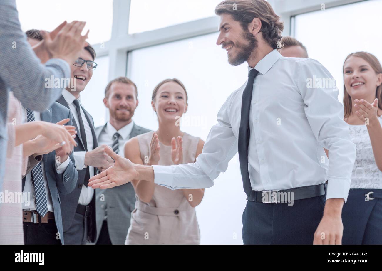 corporate group of employees congratulating each other on the victory ...