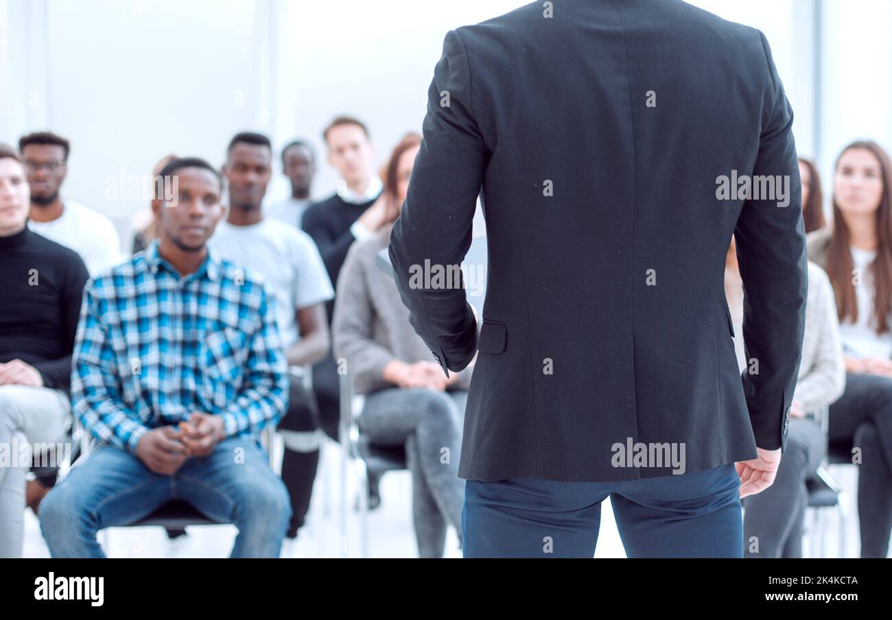 close up. speaker standing in front of a cheering audience Stock Photo ...