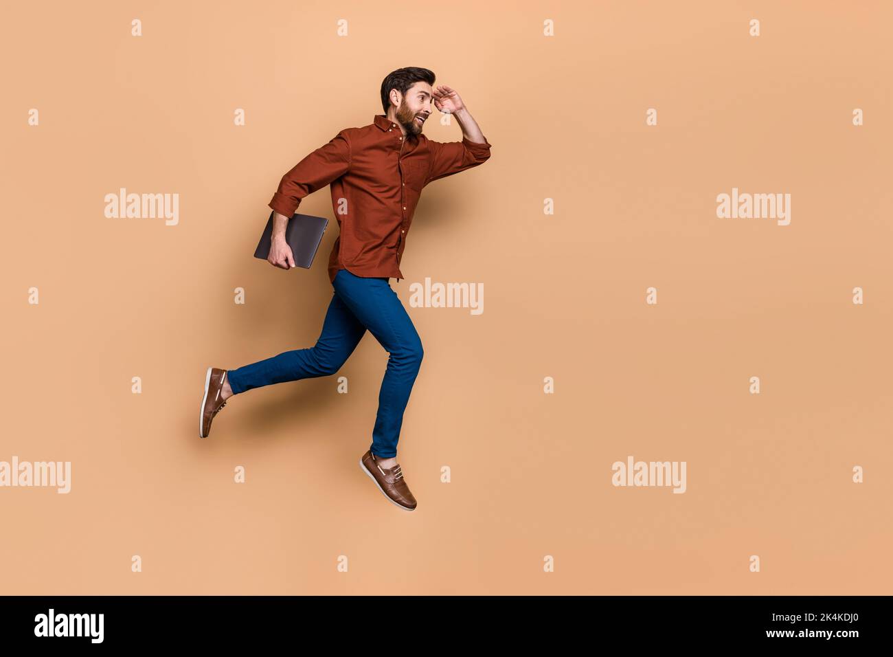 Full body portrait of energetic handsome guy jump run hand touch ...