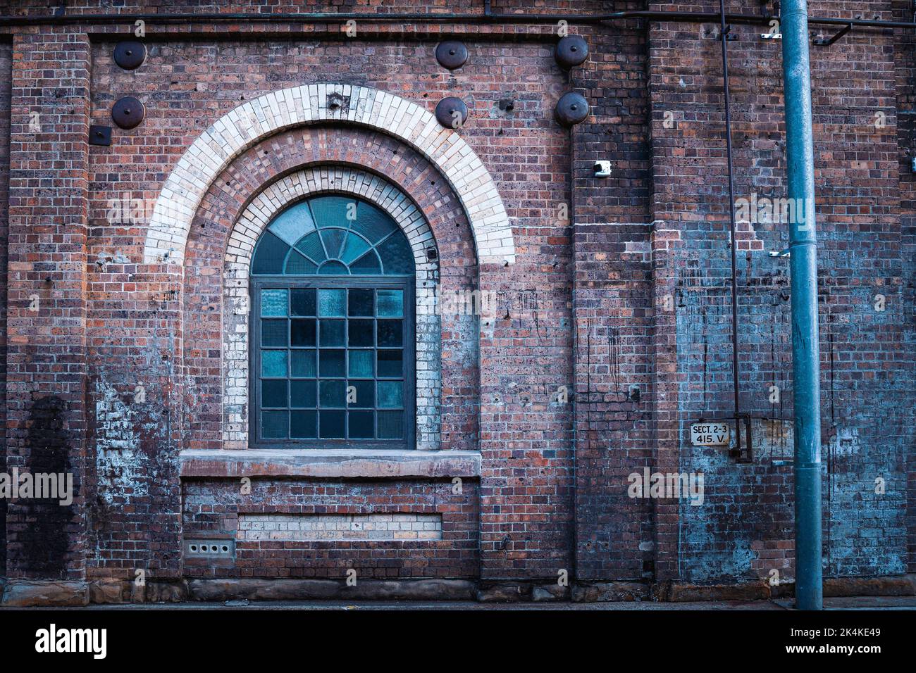 An old glass arch window in a brick wall building Stock Photo - Alamy