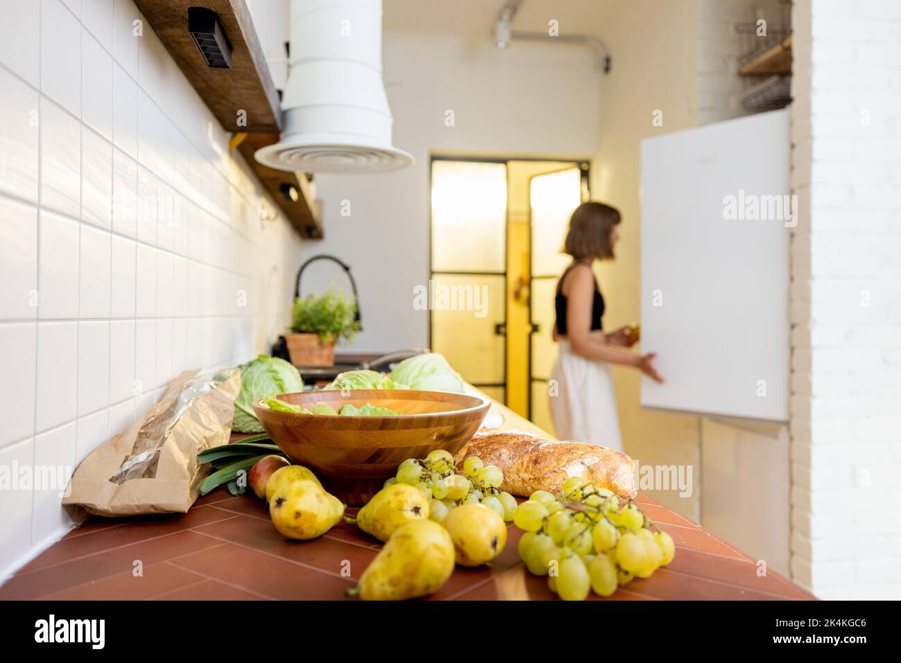 Young woman cooks healthy vegetarian food in kitchen at home Stock ...