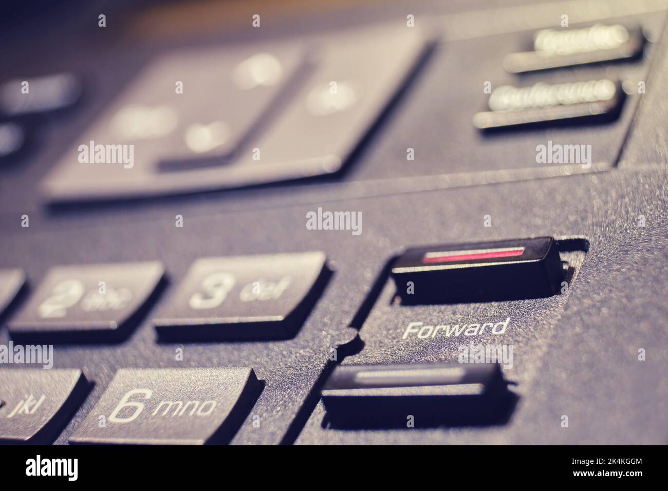 Button with text forward on a landline phone in the office, close-up ...