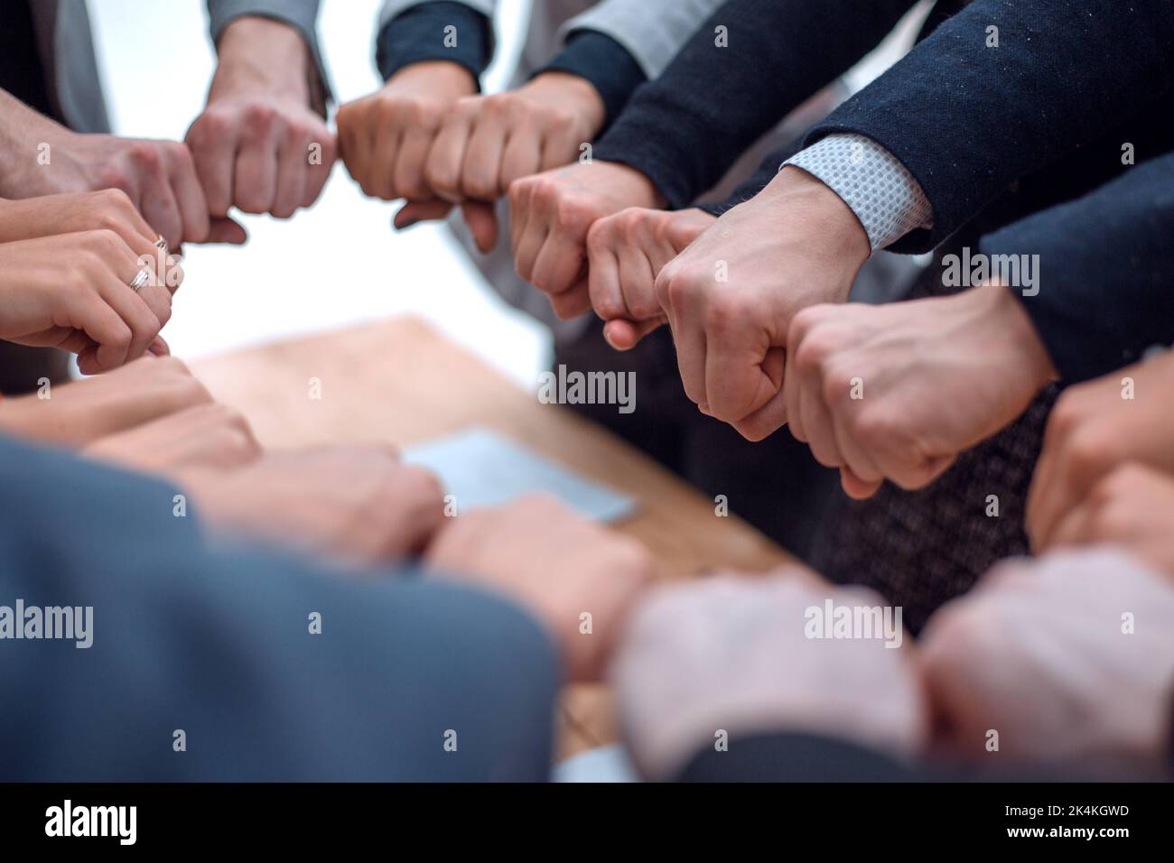 close up. the business team is making a circle of their hands over the ...