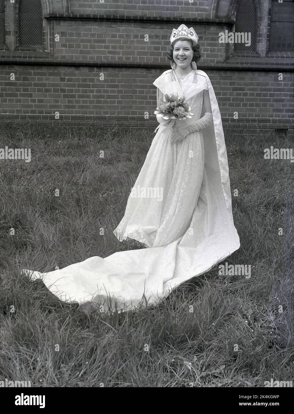 1959, historical, a teenage girl, the local May Queen, standing for her ...