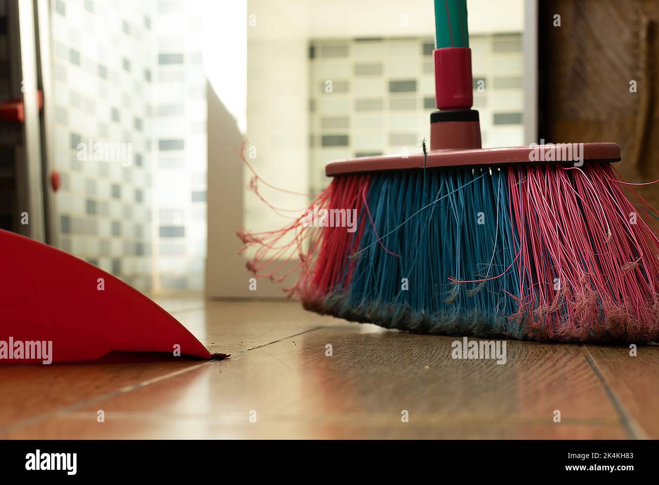Doing the cleaning with a broom and a shovel Stock Photo - Alamy