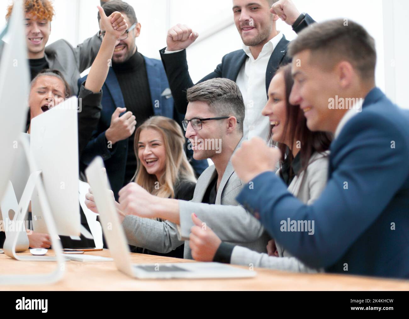 jubilant business team looking at the computer monitor Stock Photo - Alamy