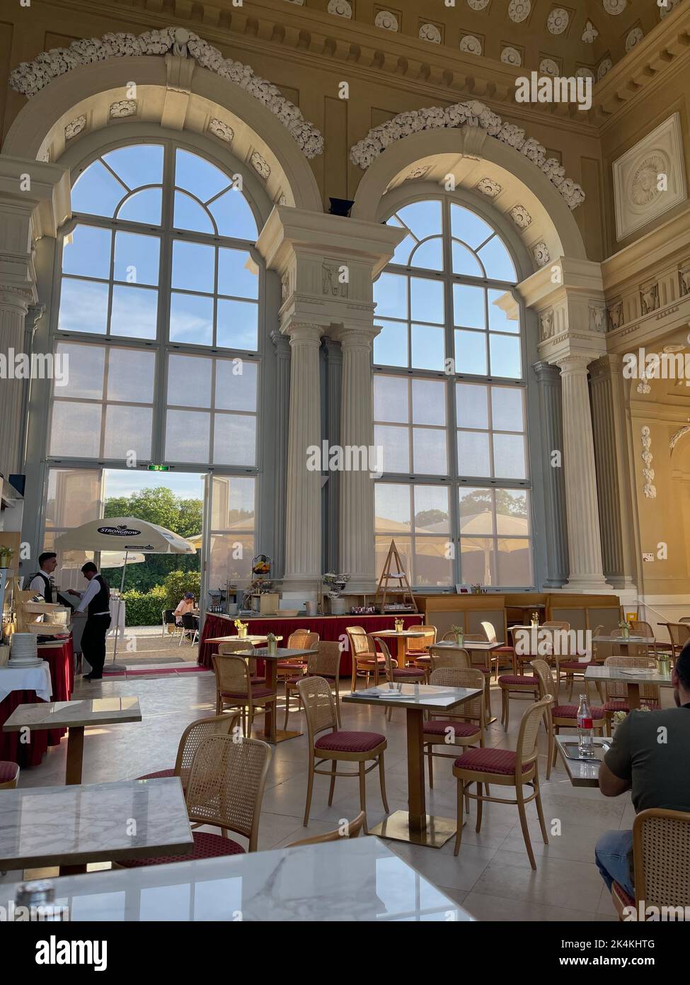 The vertical view of a vintage decorated cafe interior with tall ...