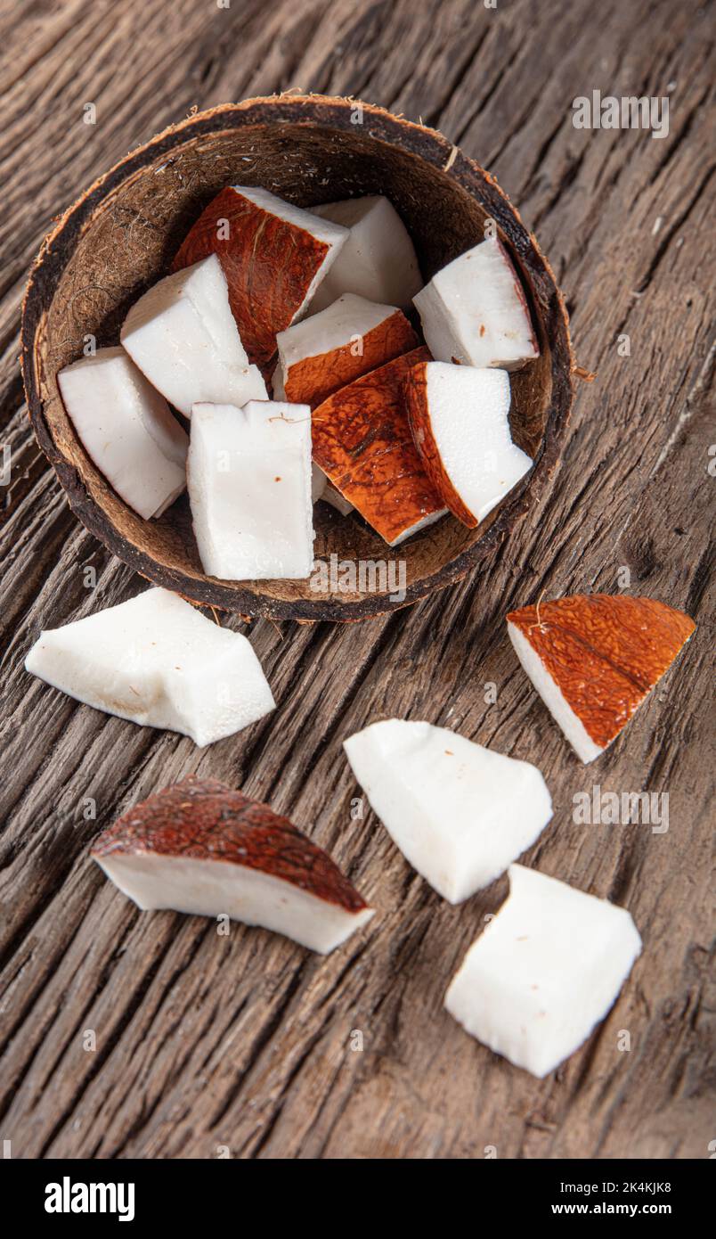 Coconut halves, coconut pieces on wooden background top view ...