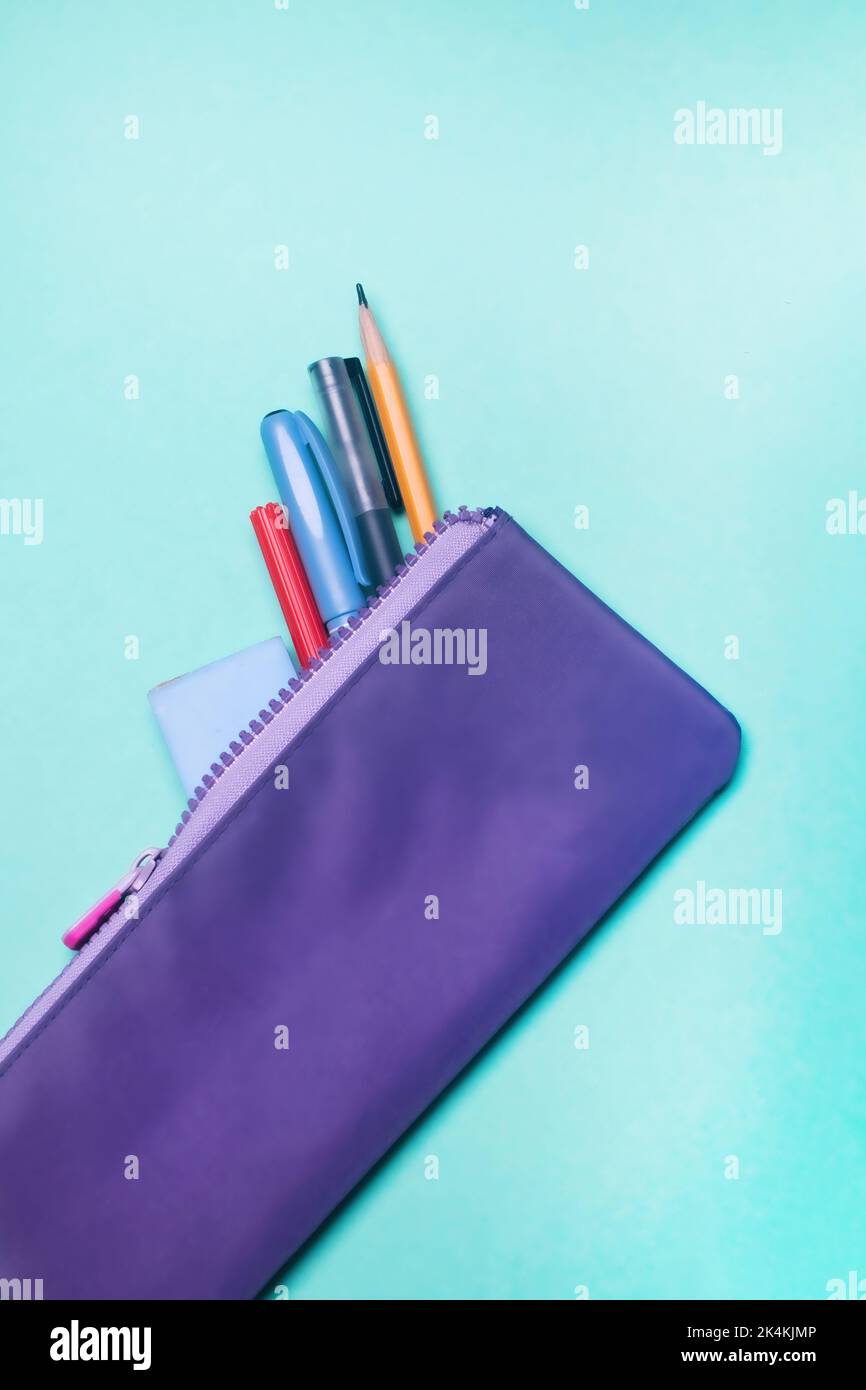 Fashionable violet pencil case with multicolored felt-tip pens, pencils ...