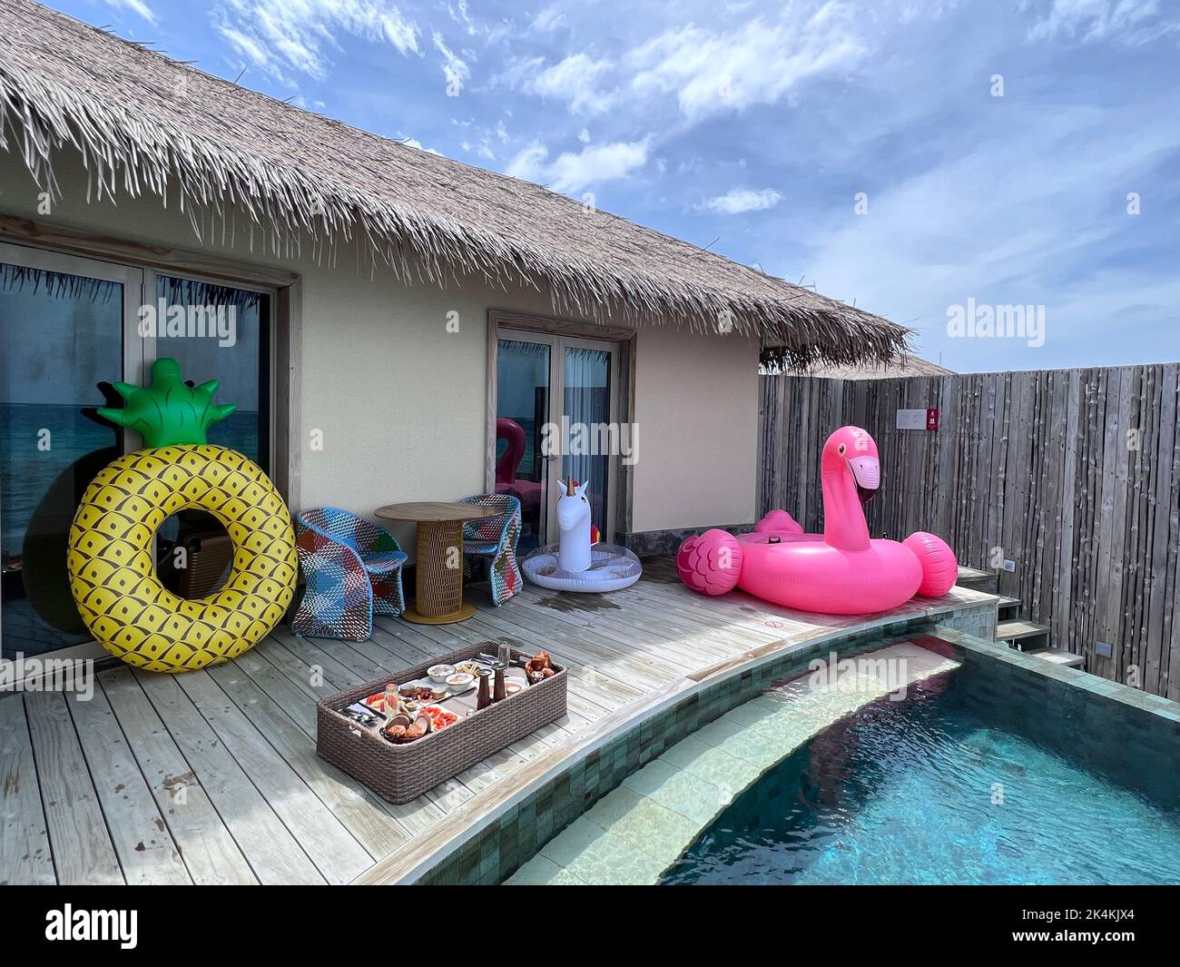 The view of a served breakfast and swimming tubes by the pool of a ...