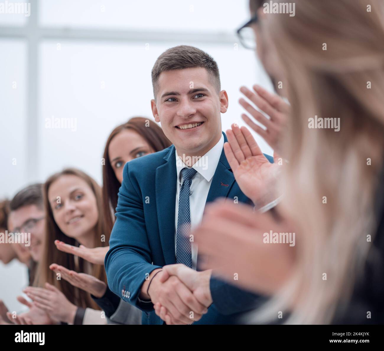 young employees greeting each other with a handshake Stock Photo - Alamy